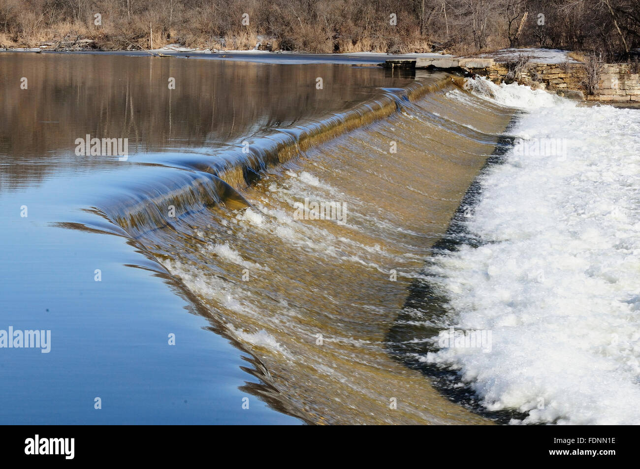 Water flowing over dam on river Stock Photo - Alamy