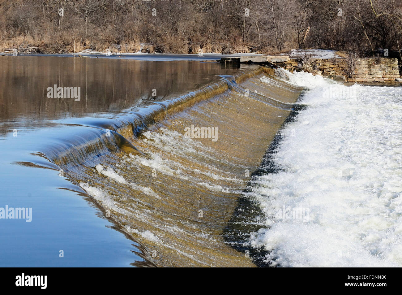 Water flowing over dam on river Stock Photo - Alamy