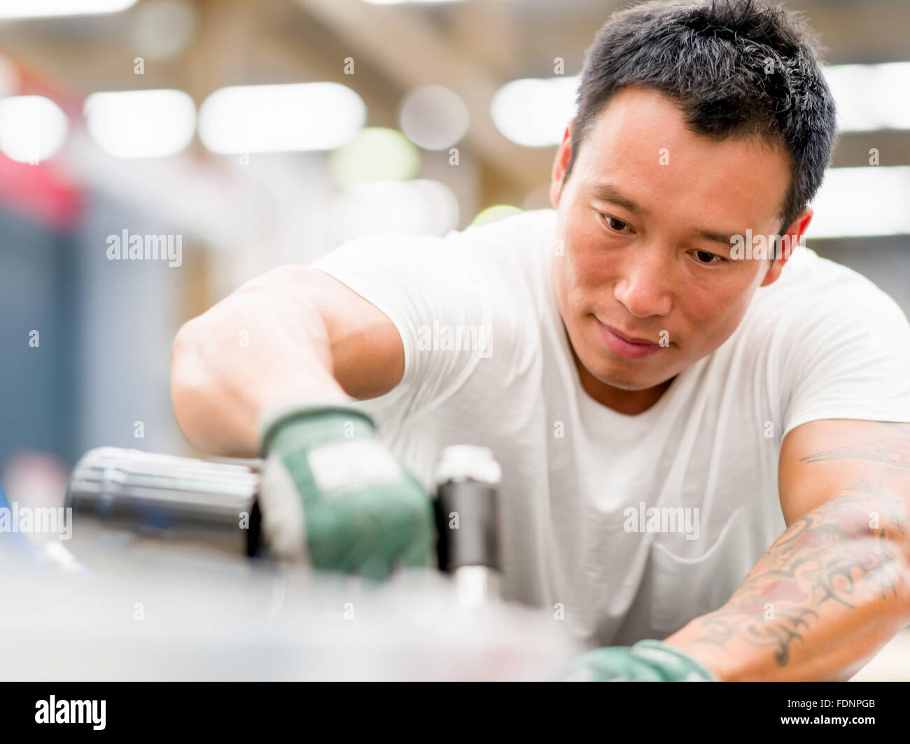 portrait of asian worker in production plant working on the factory ...