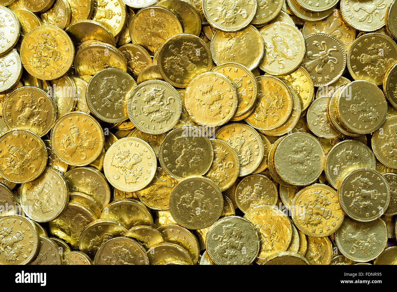 Piles of chocolate coins in golden foil Stock Photo - Alamy