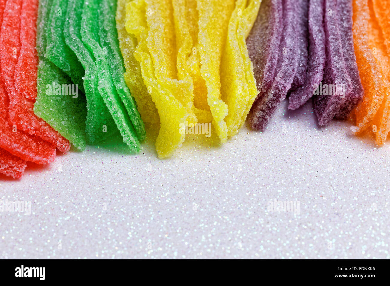 Colorful sugar jelly candy strip over white background Stock Photo - Alamy