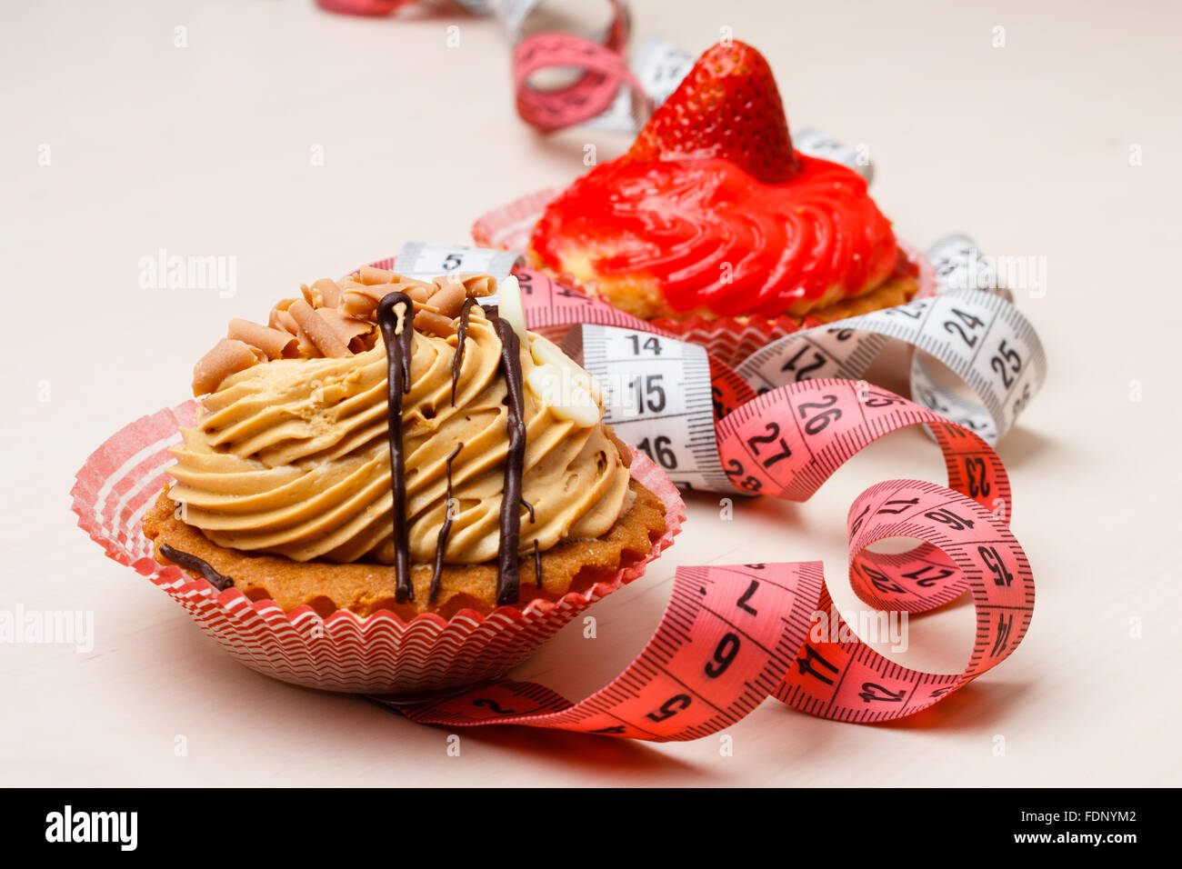 Appetite and gluttony concept. Fattening problem. Cakes cupcakes with ...