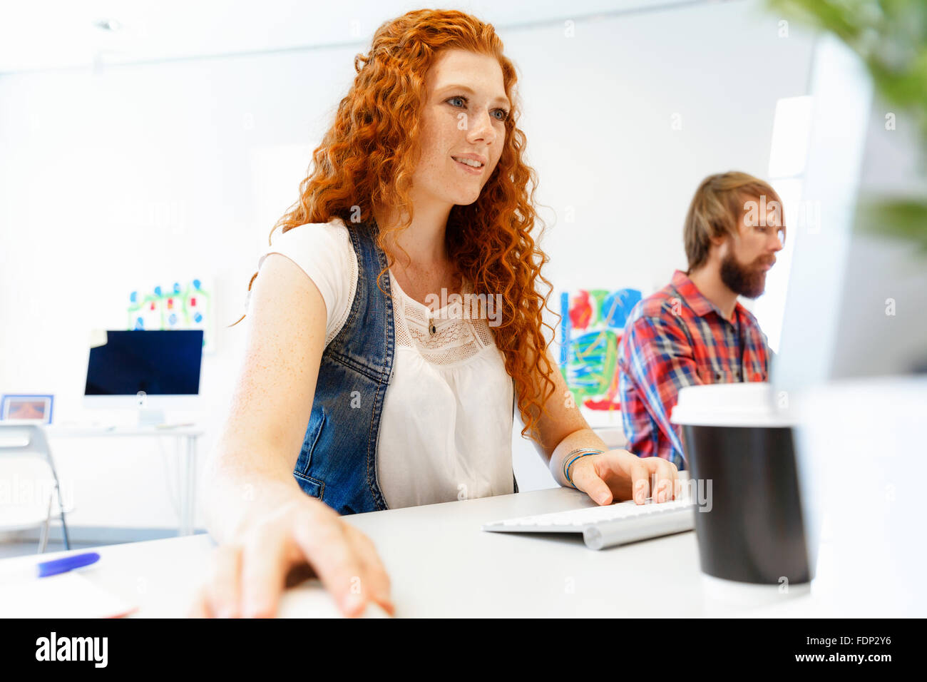 Two co-workers working together in office Stock Photo - Alamy