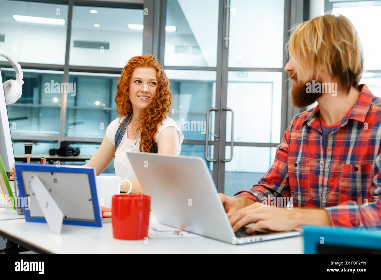 Two co-workers working together in office Stock Photo - Alamy