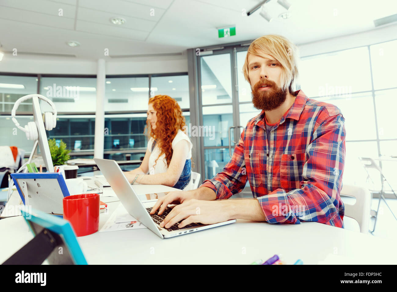 Two co-workers working together in office Stock Photo - Alamy