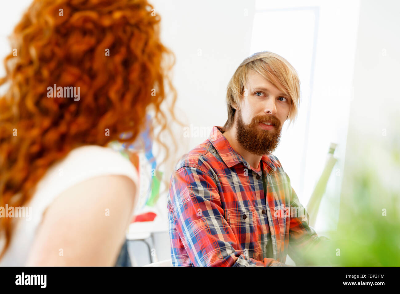 Two co-workers working together in office Stock Photo - Alamy