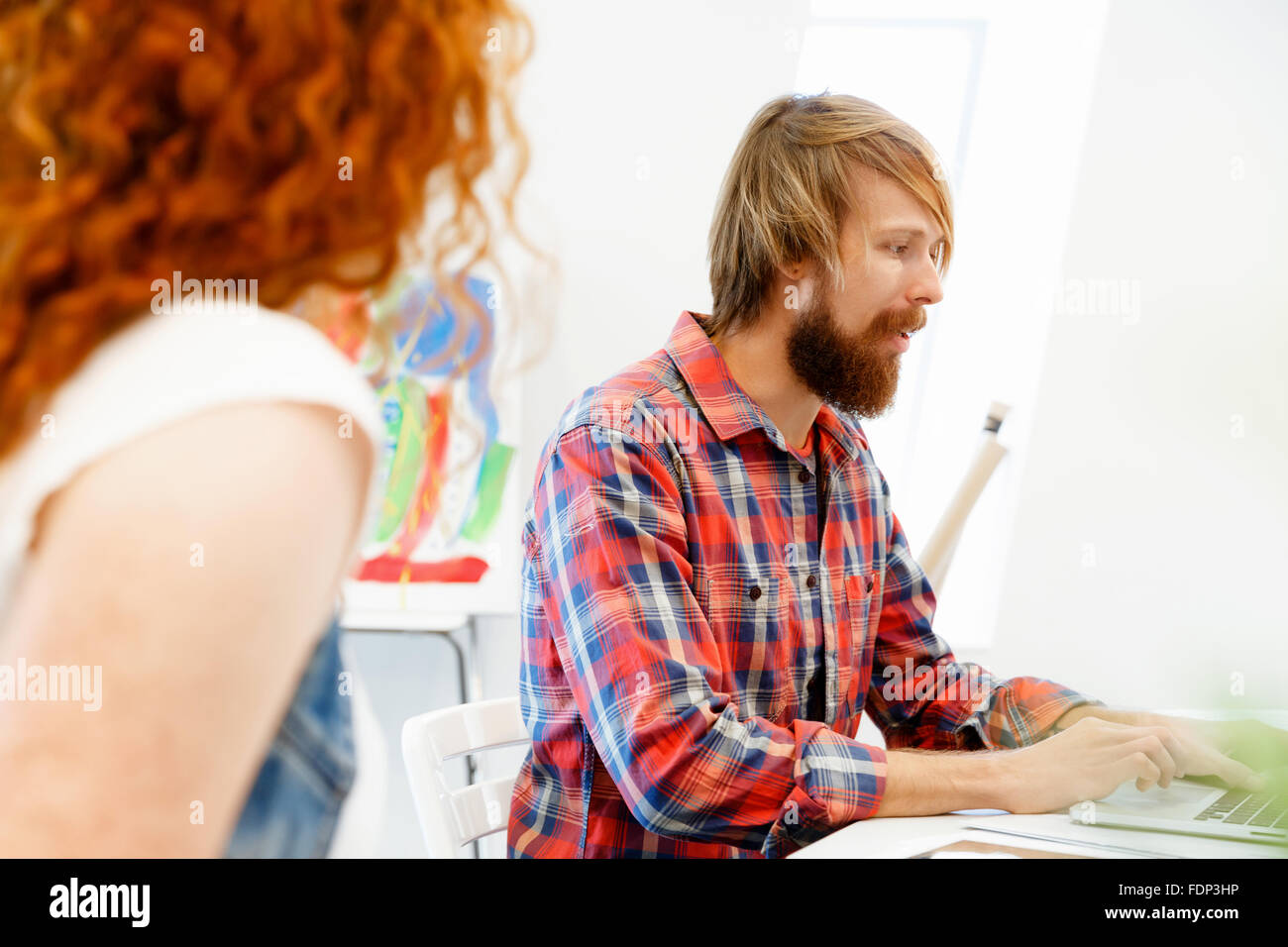 Two co-workers working together in office Stock Photo - Alamy