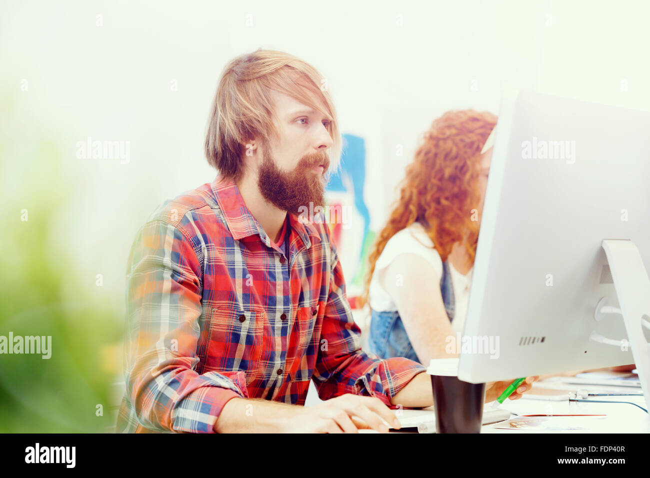 Two co-workers working together in office Stock Photo - Alamy