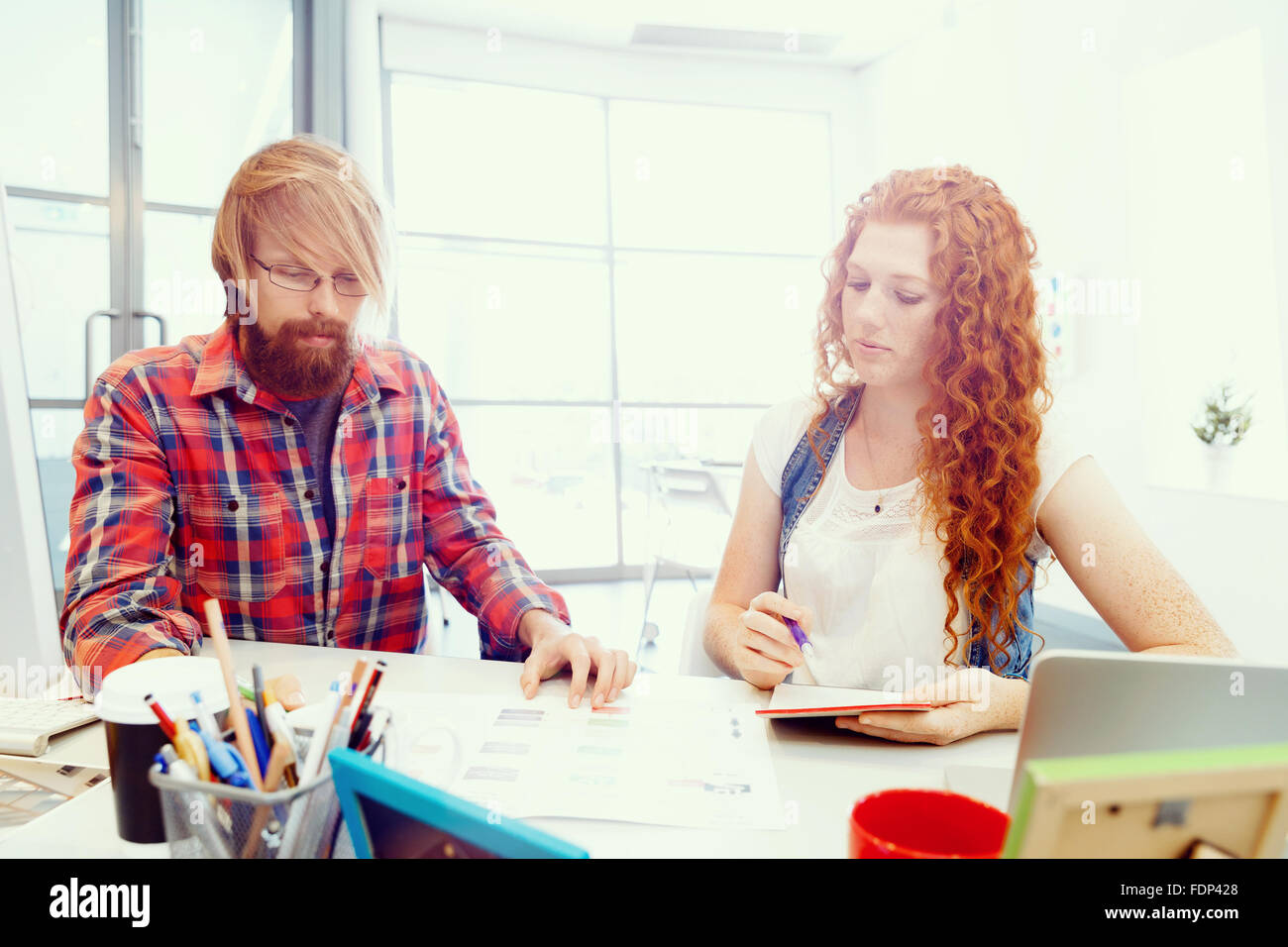 Two co-workers working together in office Stock Photo - Alamy