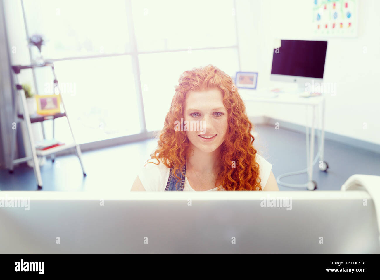 Young and pretty business woman working in office Stock Photo - Alamy