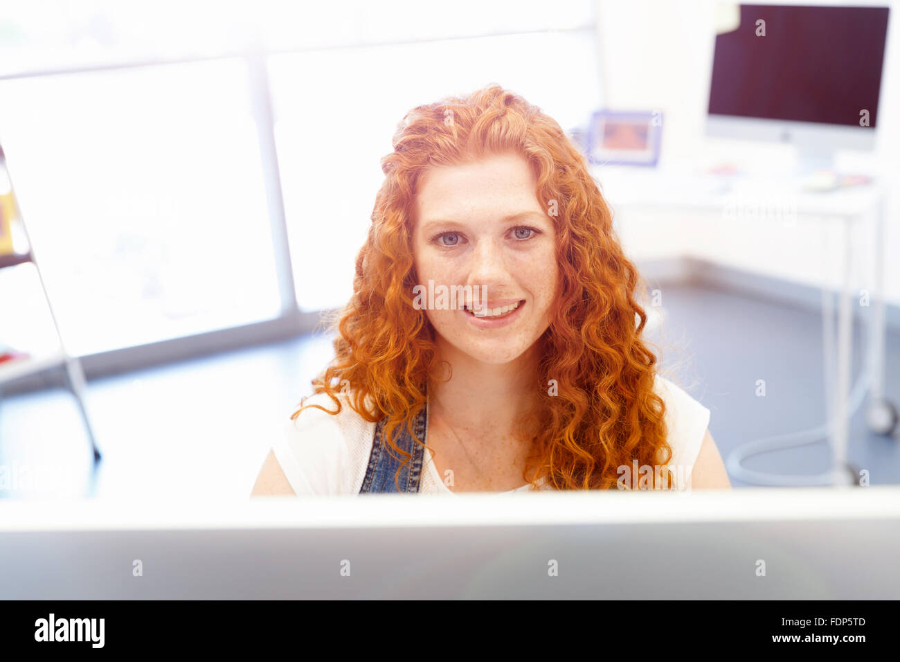 Young and pretty business woman working in office Stock Photo - Alamy