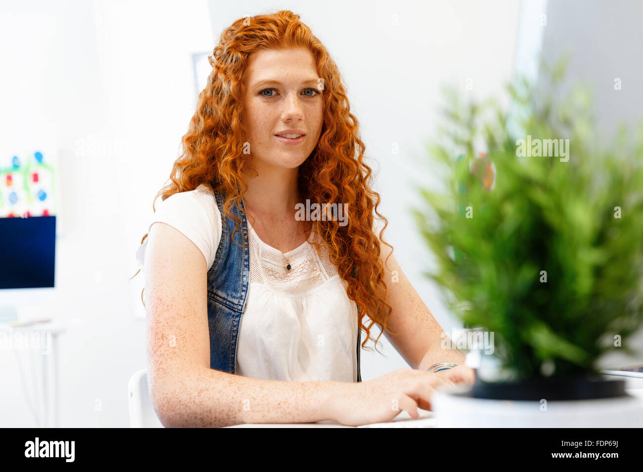 Young and pretty business woman working in office Stock Photo - Alamy