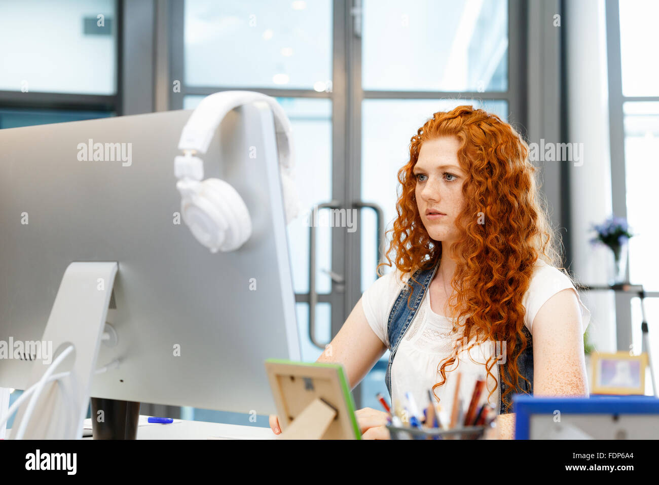 Young and pretty business woman working in office Stock Photo - Alamy