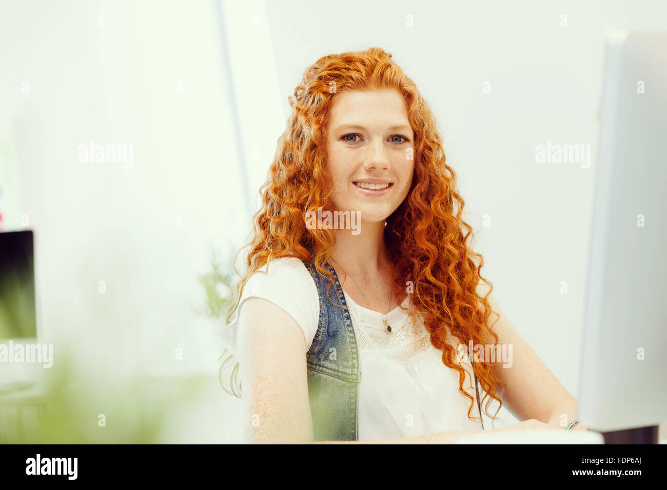 Young and pretty business woman working in office Stock Photo - Alamy