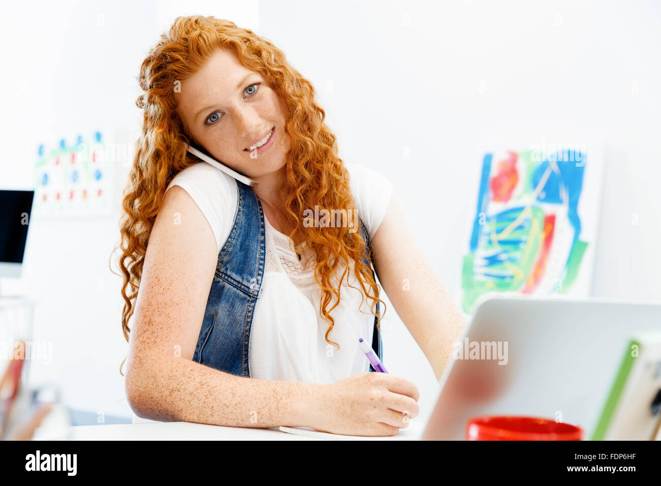 Young and pretty business woman working in office Stock Photo - Alamy