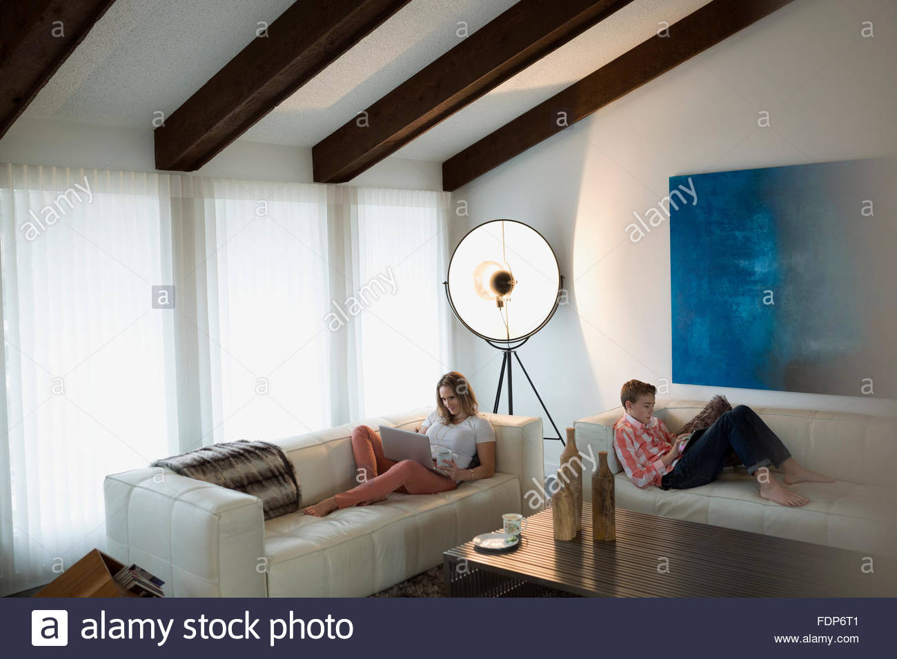 Mother and son using laptop digital tablet sofas Stock Photo - Alamy