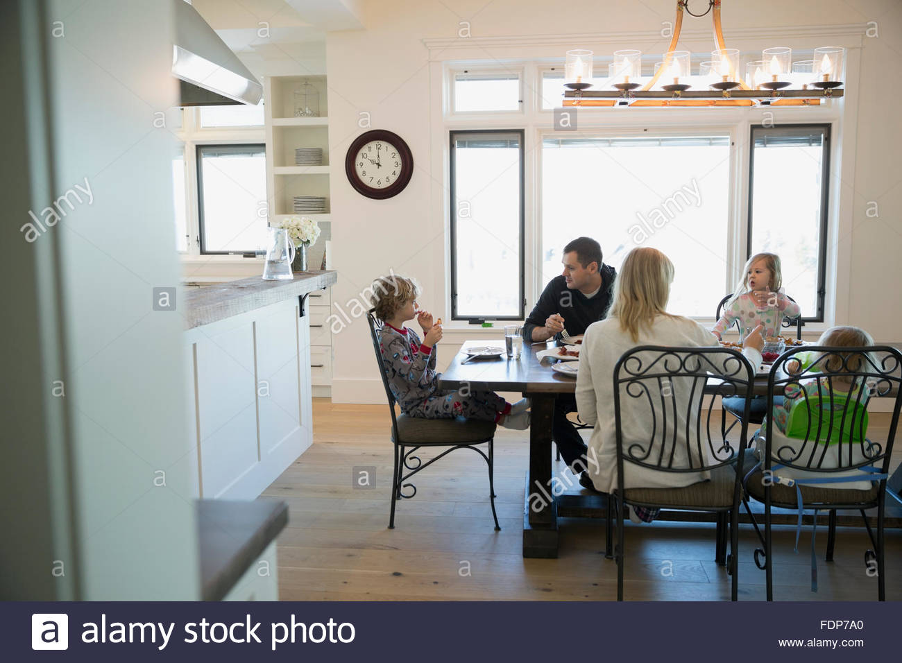 Family eating at breakfast table Stock Photo - Alamy