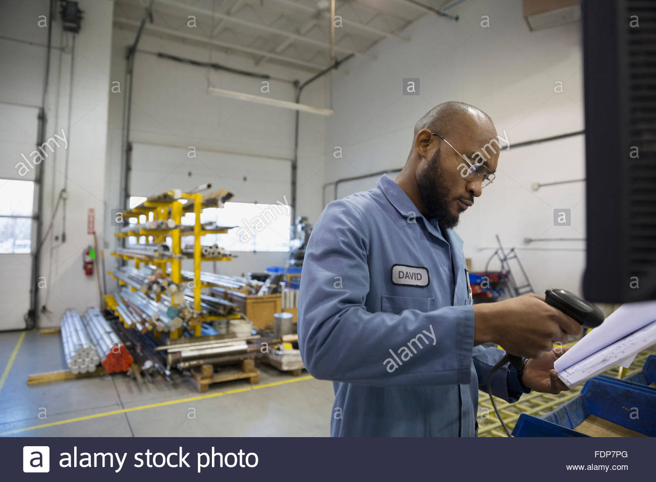 Worker scanning paperwork in factory Stock Photo - Alamy