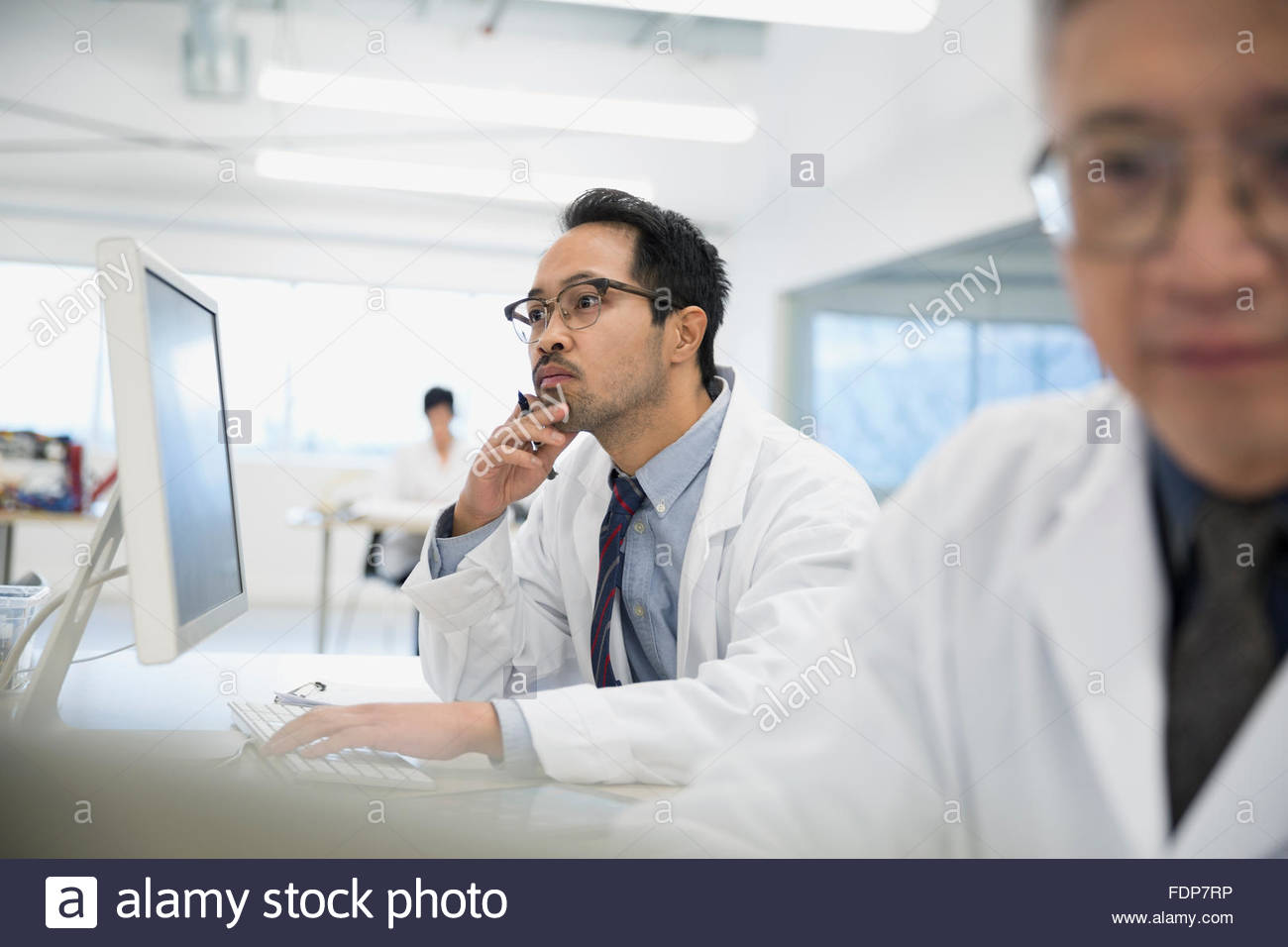 Engineer working at computer in factory Stock Photo - Alamy