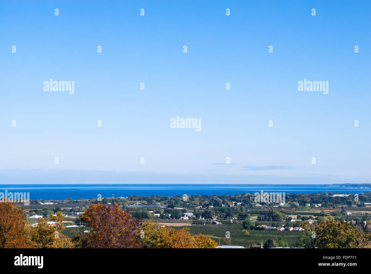Edge of semi-rural area by water against big expansive empty sky in ...