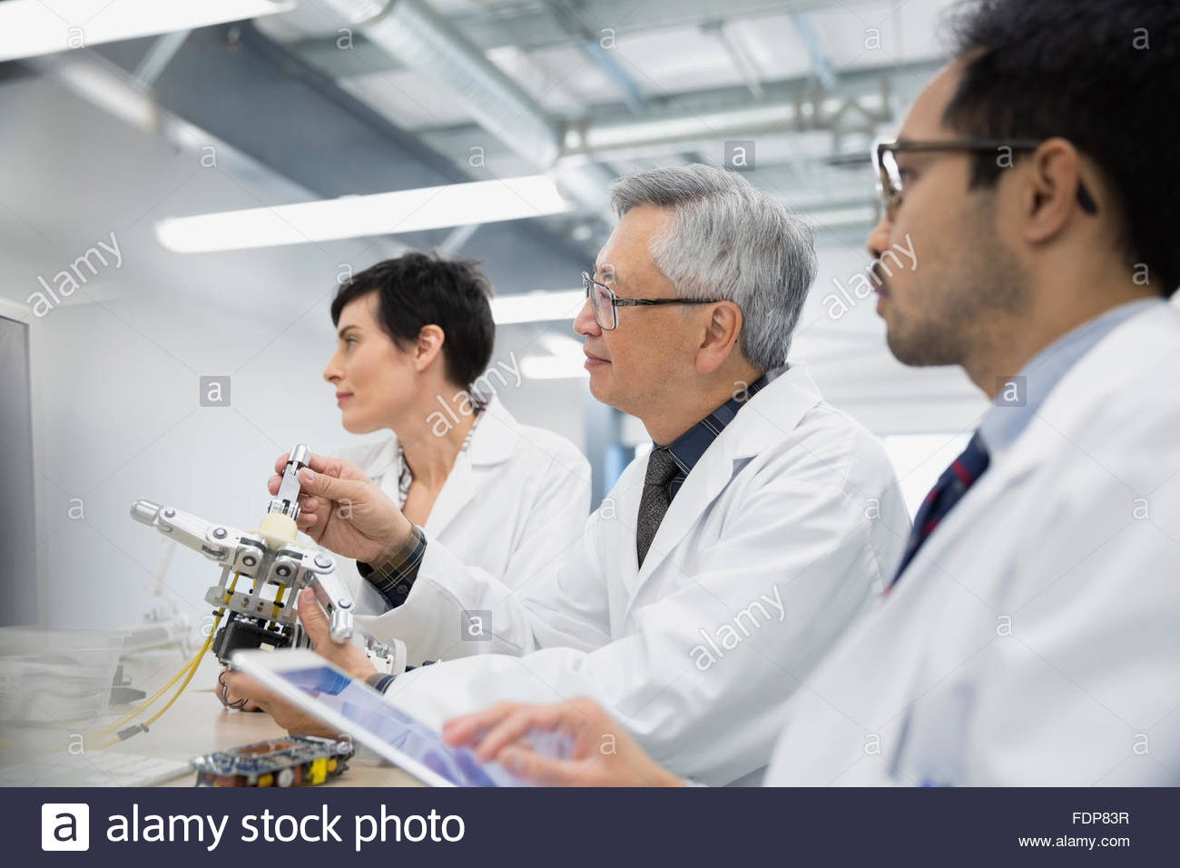 Engineers assembling robotics in factory Stock Photo - Alamy
