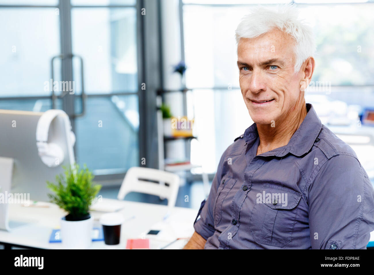 Handsome businessman in casual wear working in office Stock Photo - Alamy