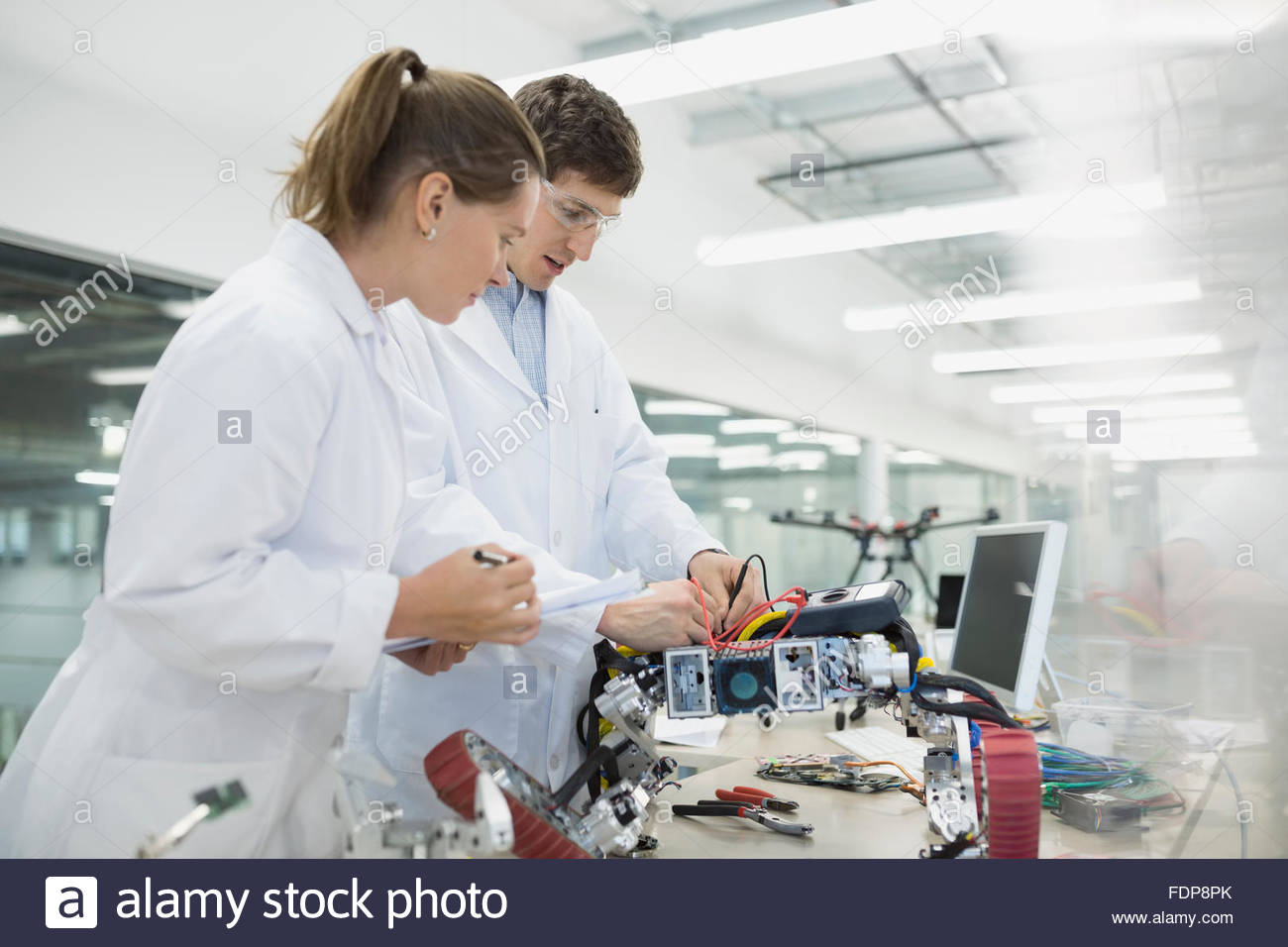 Engineers assembling robotics in factory Stock Photo - Alamy