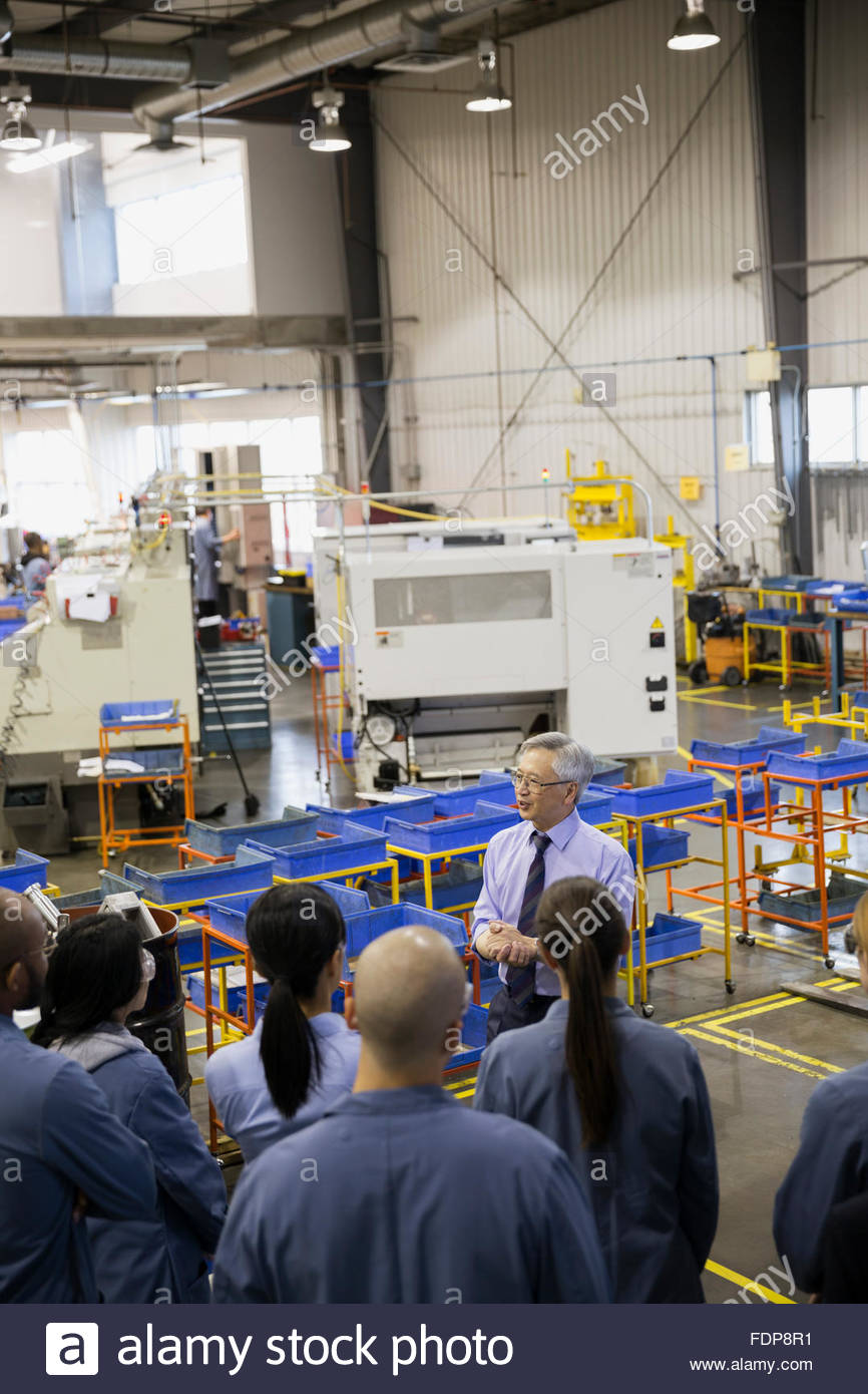 Manager leading team meeting in factory Stock Photo - Alamy