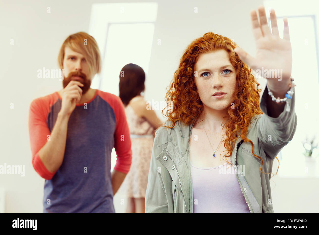 Young artists in gallery hanging together painting on walls Stock Photo ...