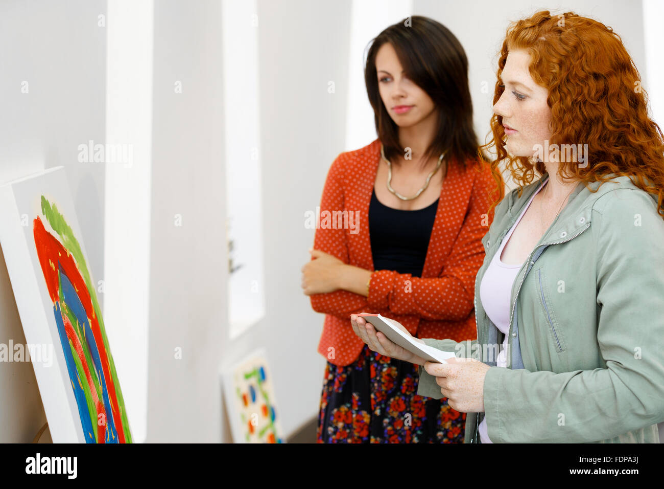 two young women in a gallery and contemplating abstract artwork Stock ...