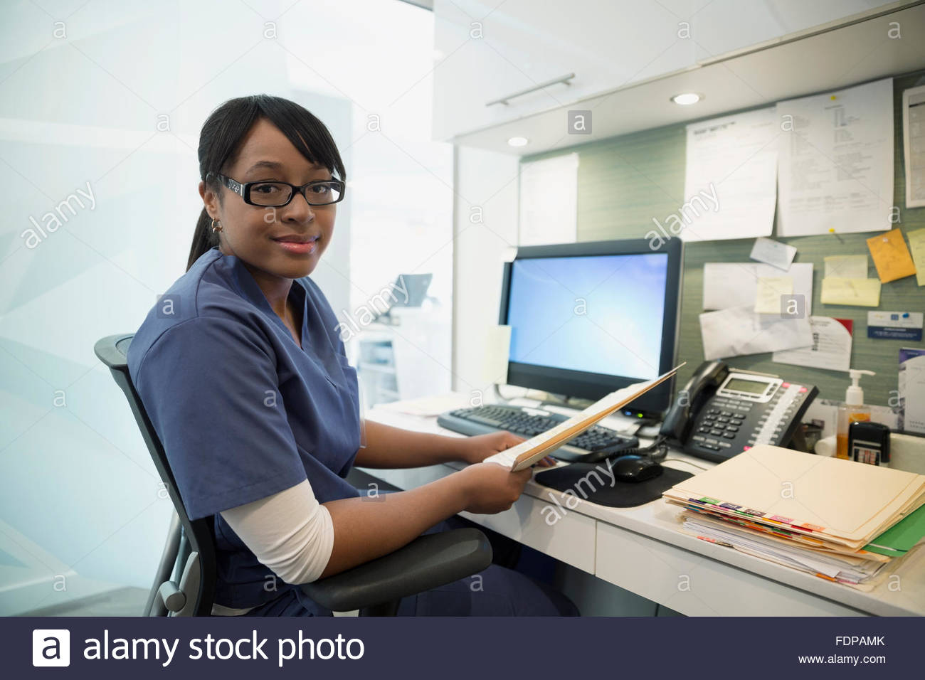 Portrait confident nurse at desk at nurses station Stock Photo - Alamy