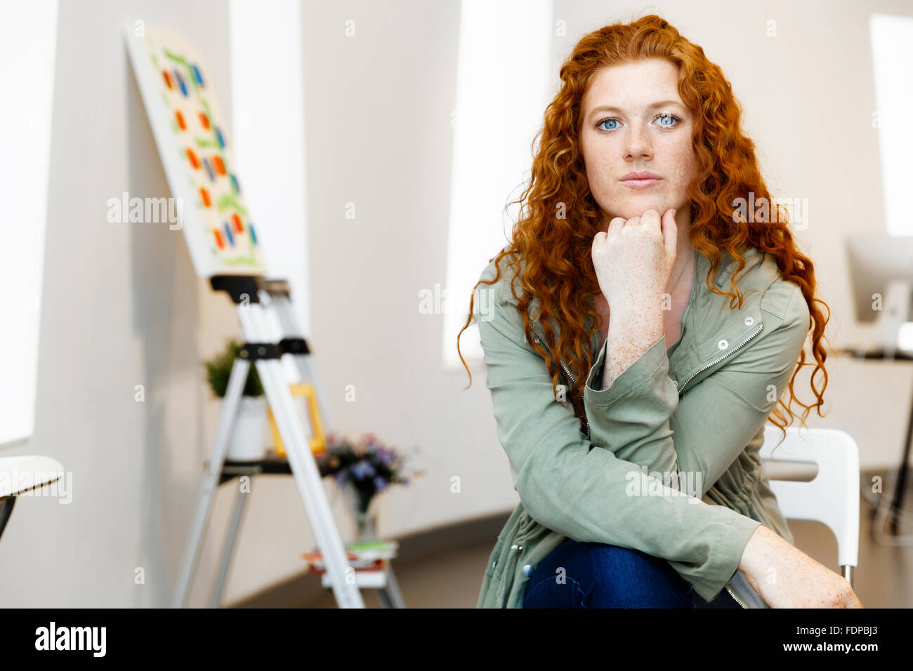 Young female artist in gallery with her picture Stock Photo - Alamy