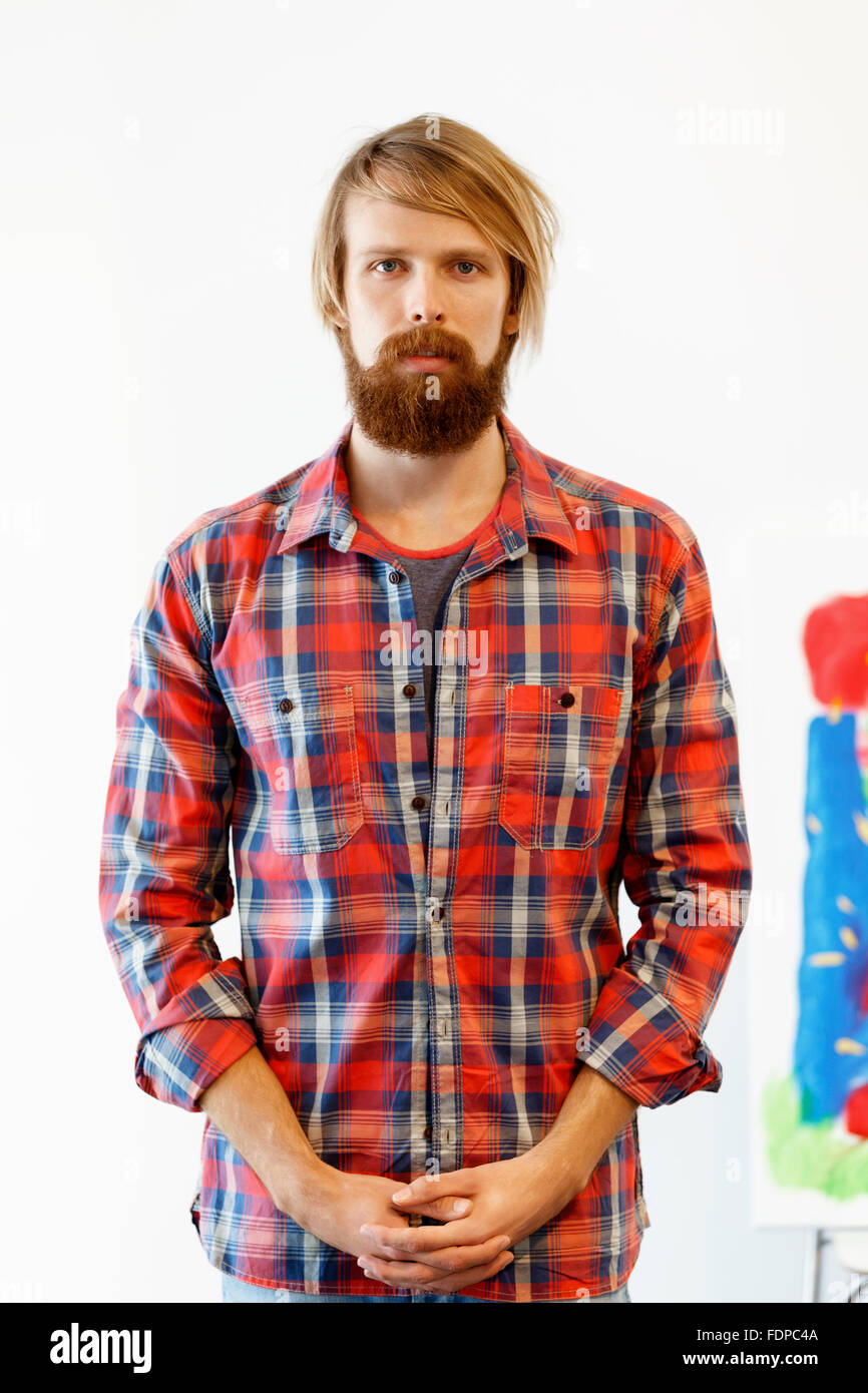 Young male artist standing with his picture Stock Photo - Alamy