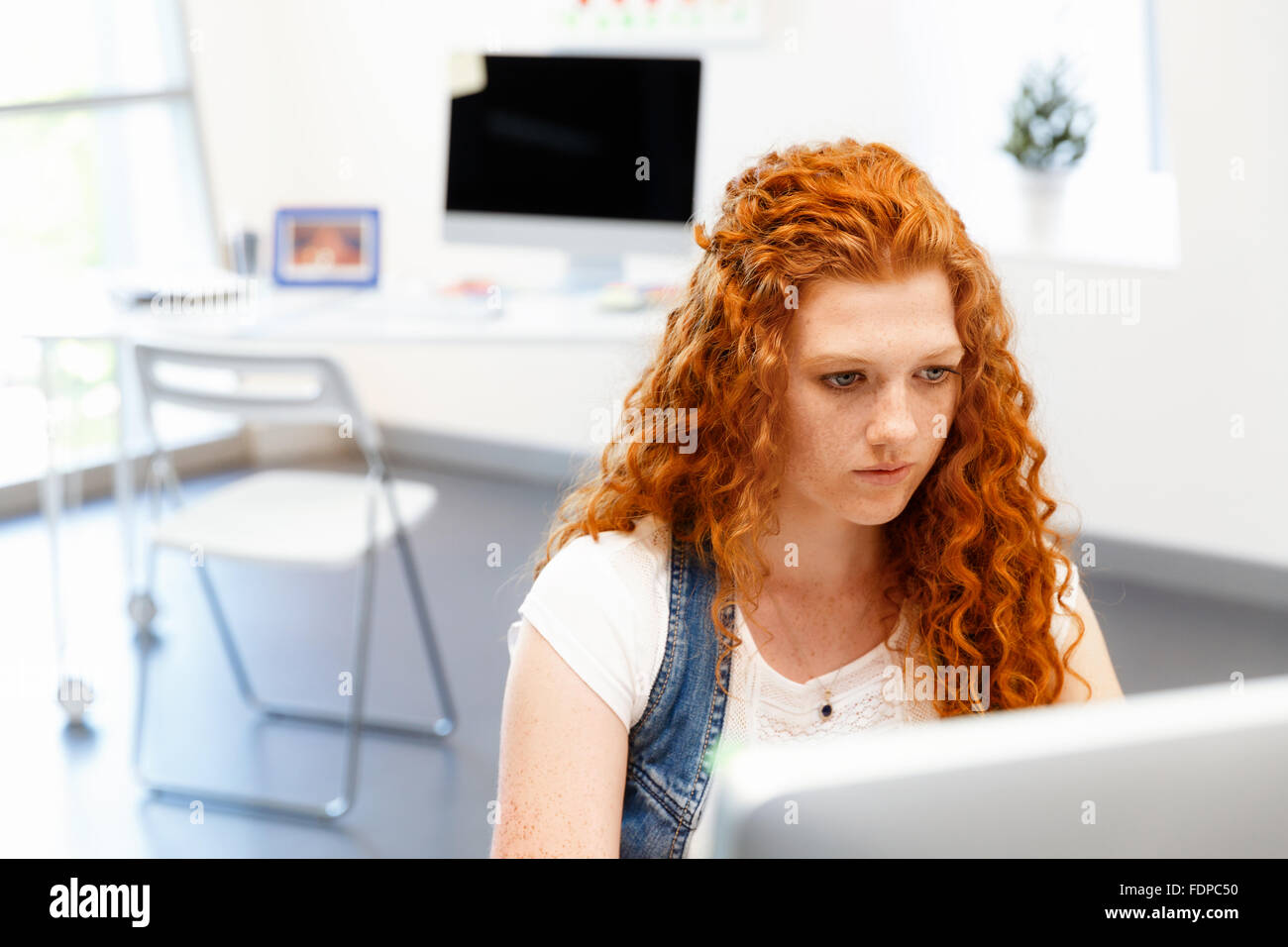 Young and pretty business woman working in office Stock Photo - Alamy
