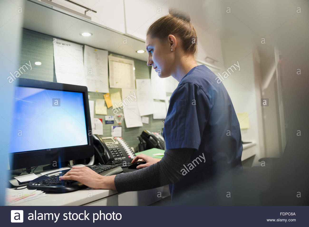 Nurse using computer at nurses station Stock Photo, Royalty Free Image ...