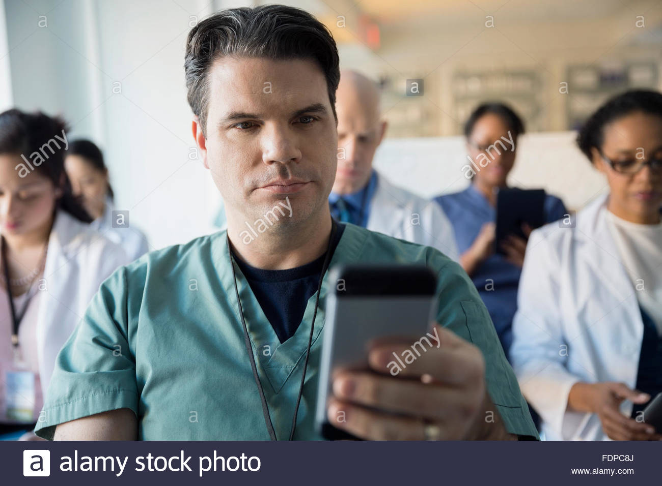 Doctor using cell phone in seminar audience Stock Photo - Alamy