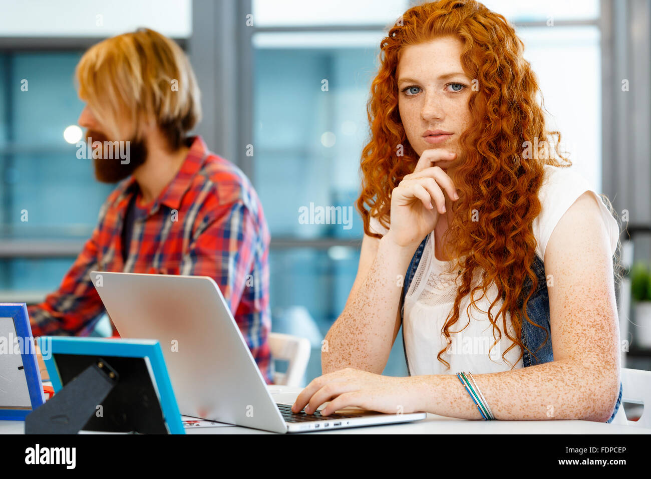 Young and pretty business woman working in office Stock Photo - Alamy