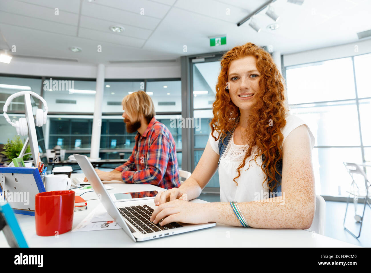 Young and pretty business woman working in office Stock Photo - Alamy