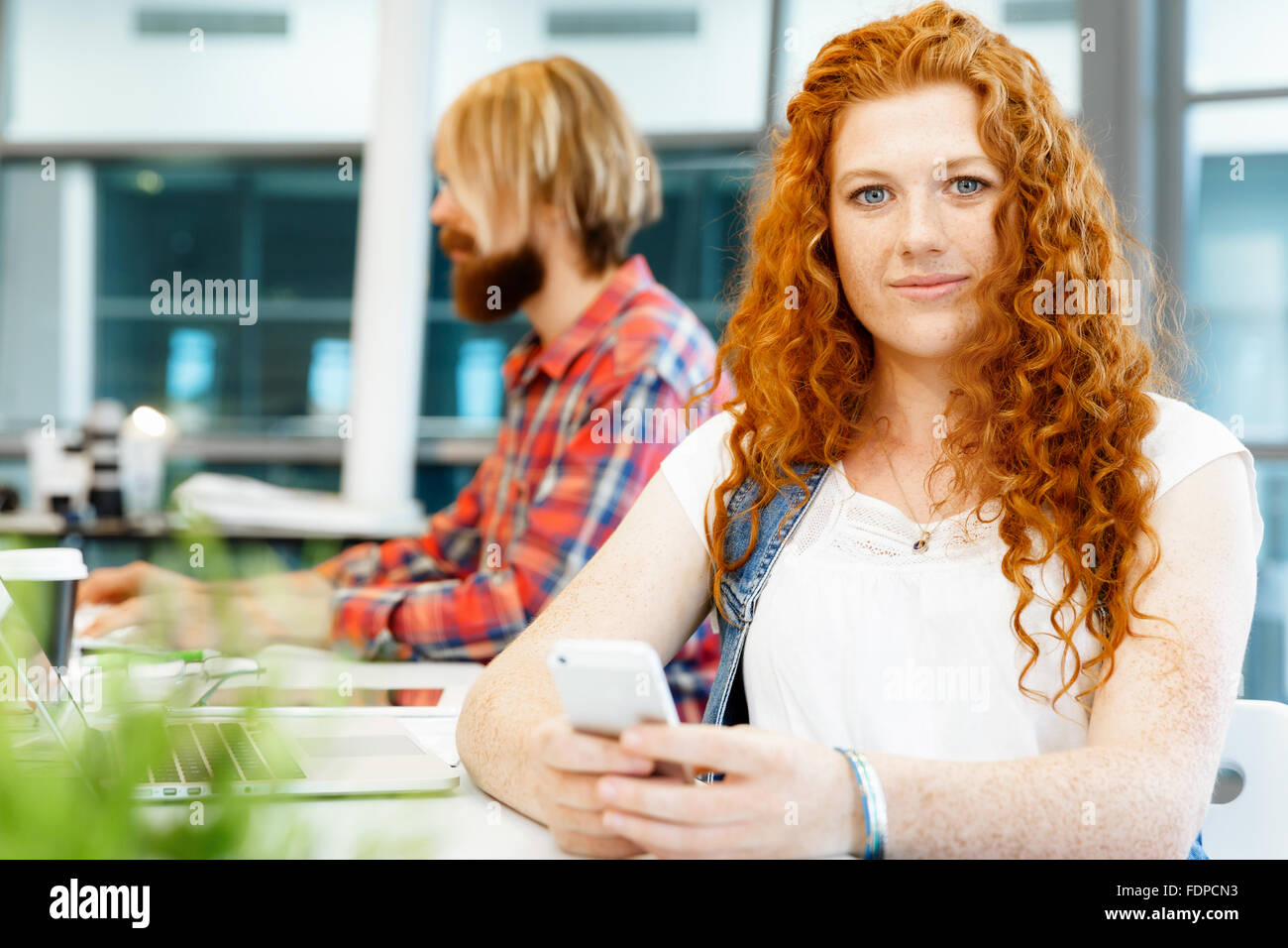 Young and pretty business woman working in office Stock Photo - Alamy