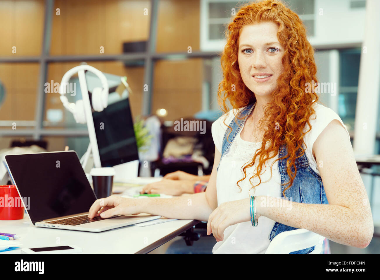Young and pretty business woman working in office Stock Photo - Alamy