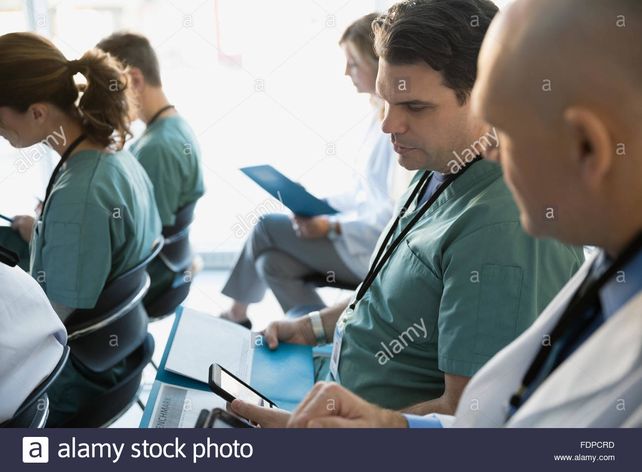 Doctors texting in seminar audience Stock Photo - Alamy