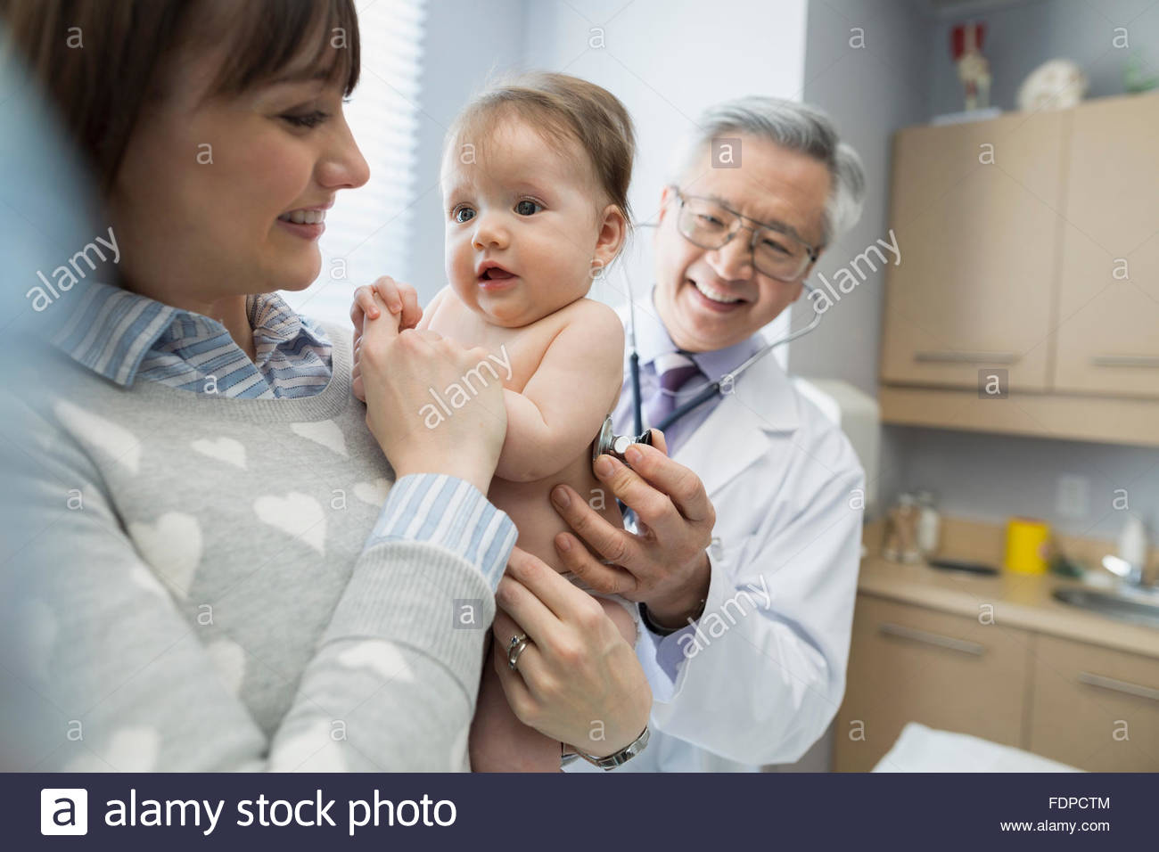 pediatrician examining baby stethoscope mother Stock Photo - Alamy