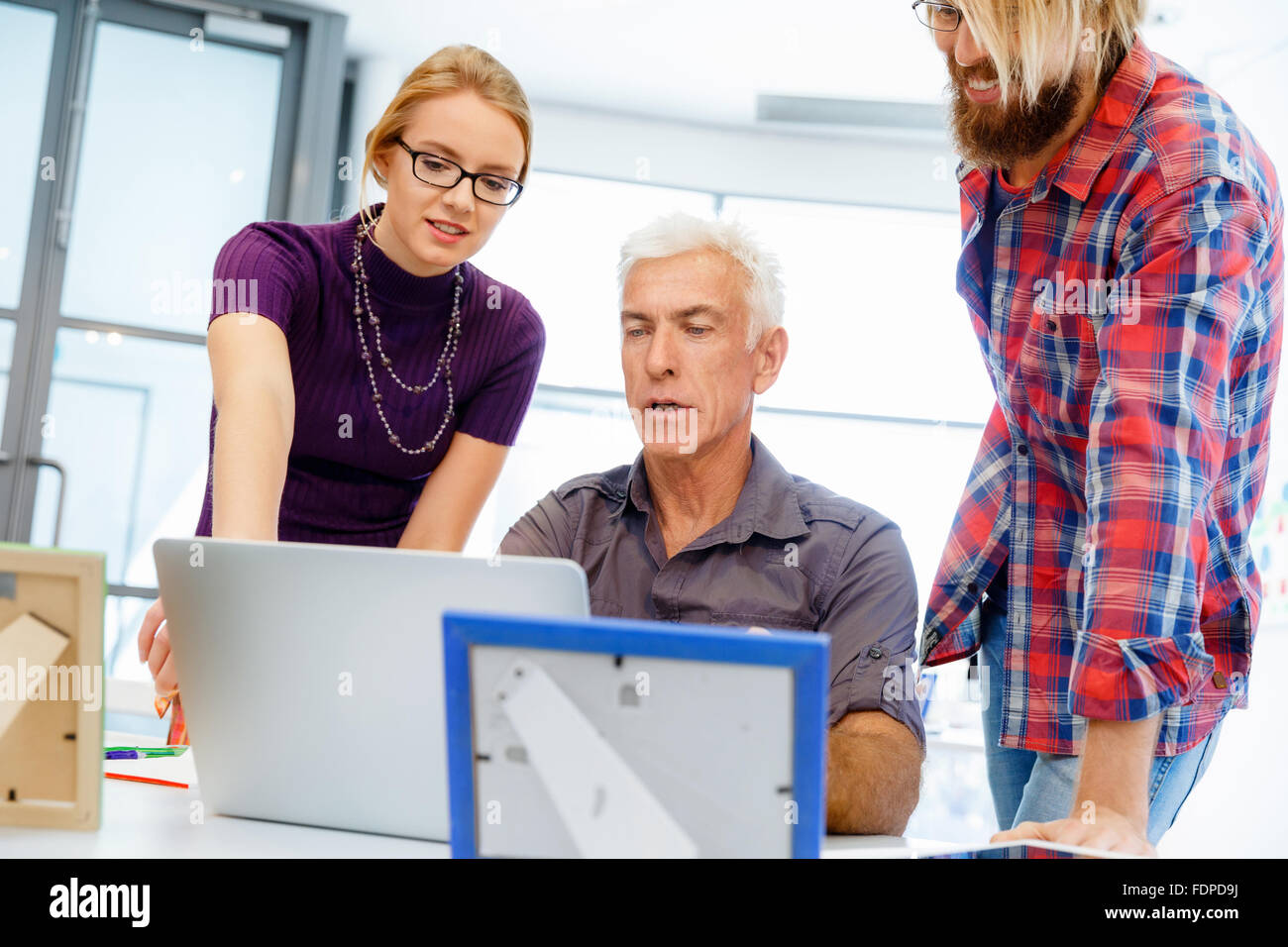 Business team working together in office Stock Photo - Alamy