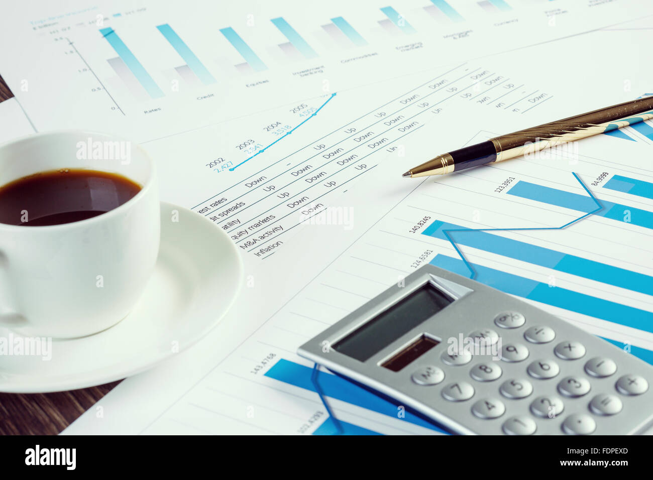 financial charts and graphs and a cup of coffee Stock Photo - Alamy