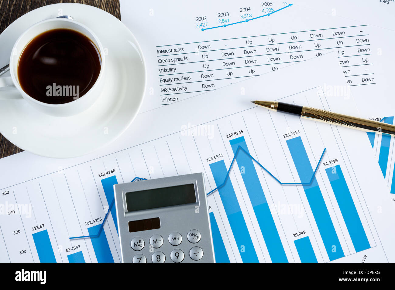 financial charts and graphs and a cup of coffee Stock Photo - Alamy