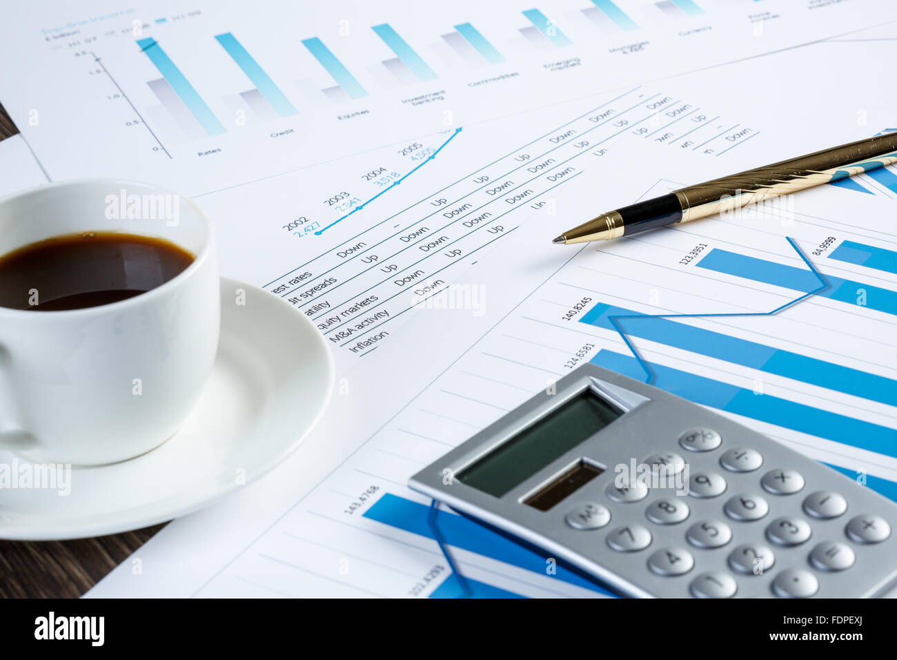 financial charts and graphs and a cup of coffee Stock Photo - Alamy