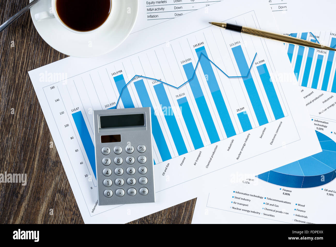 financial charts and graphs and a cup of coffee Stock Photo - Alamy