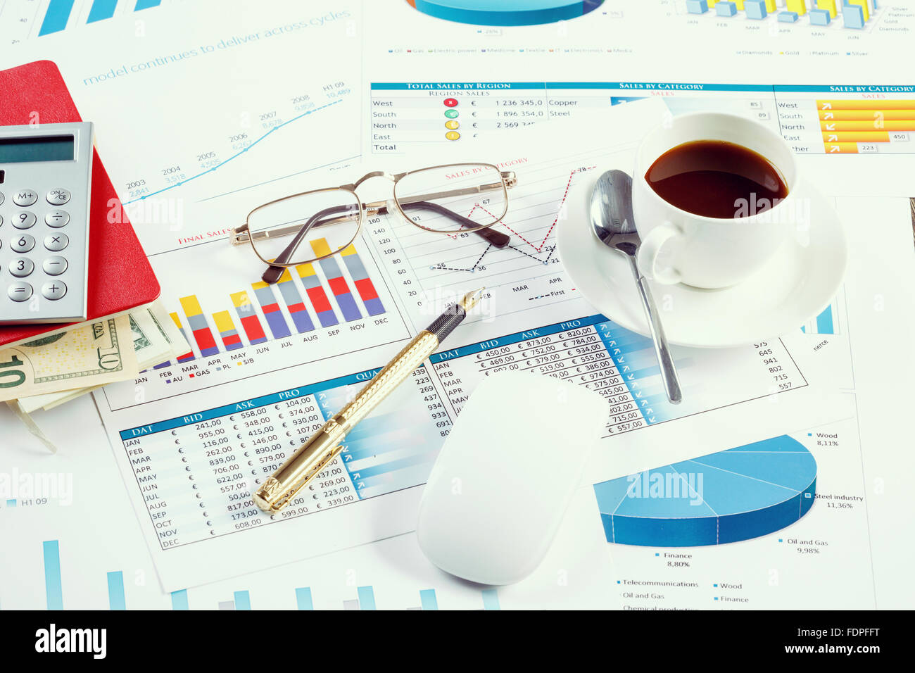 financial charts and graphs and a cup of coffee Stock Photo - Alamy