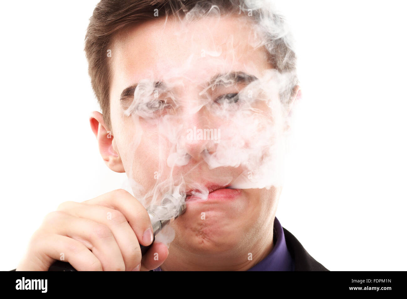 Portrait of a man in suit smoking an e-cigarette isolated on white. Let ...