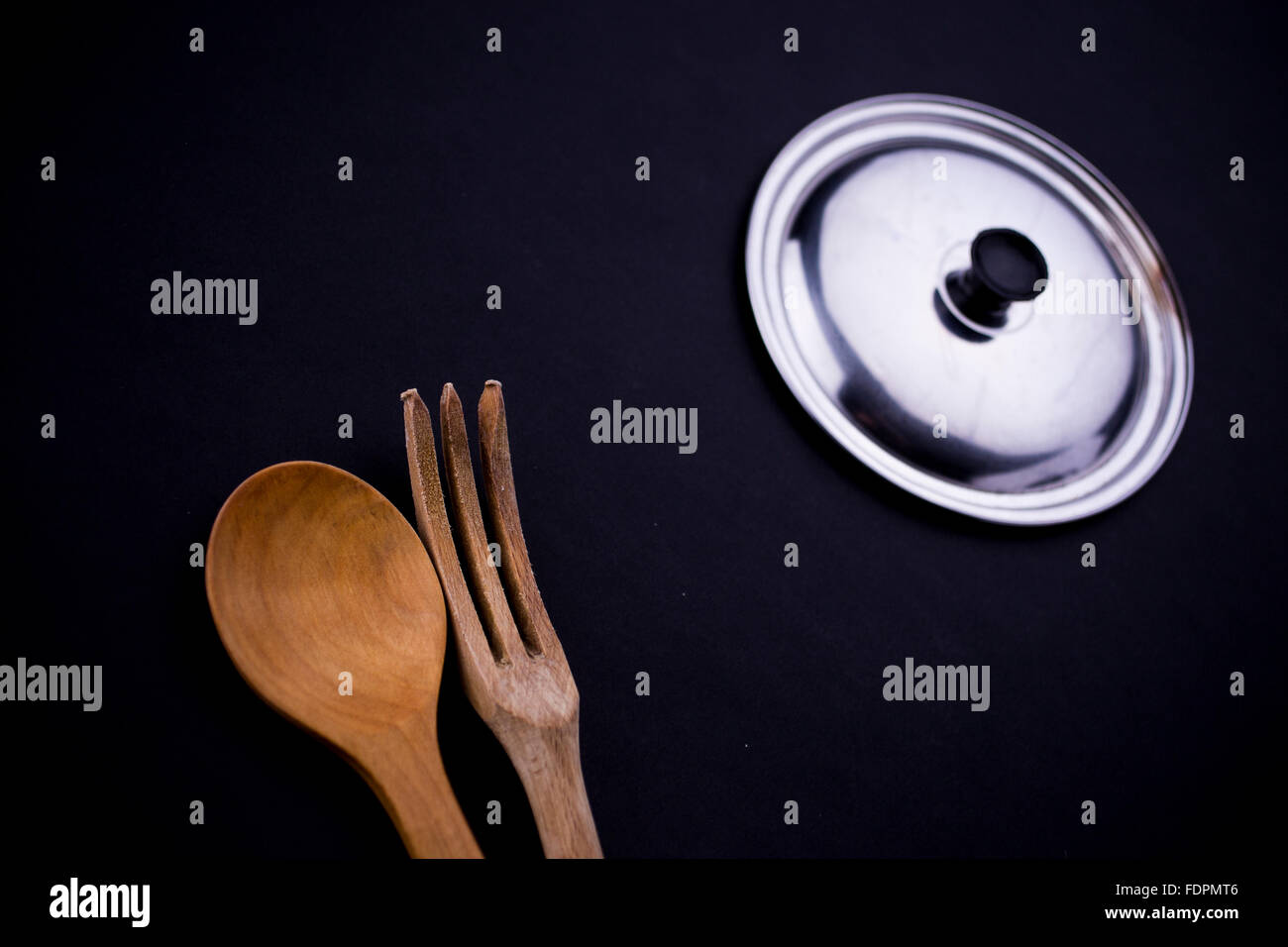 Still life of wooden carved cutlery isolated on black Stock Photo - Alamy